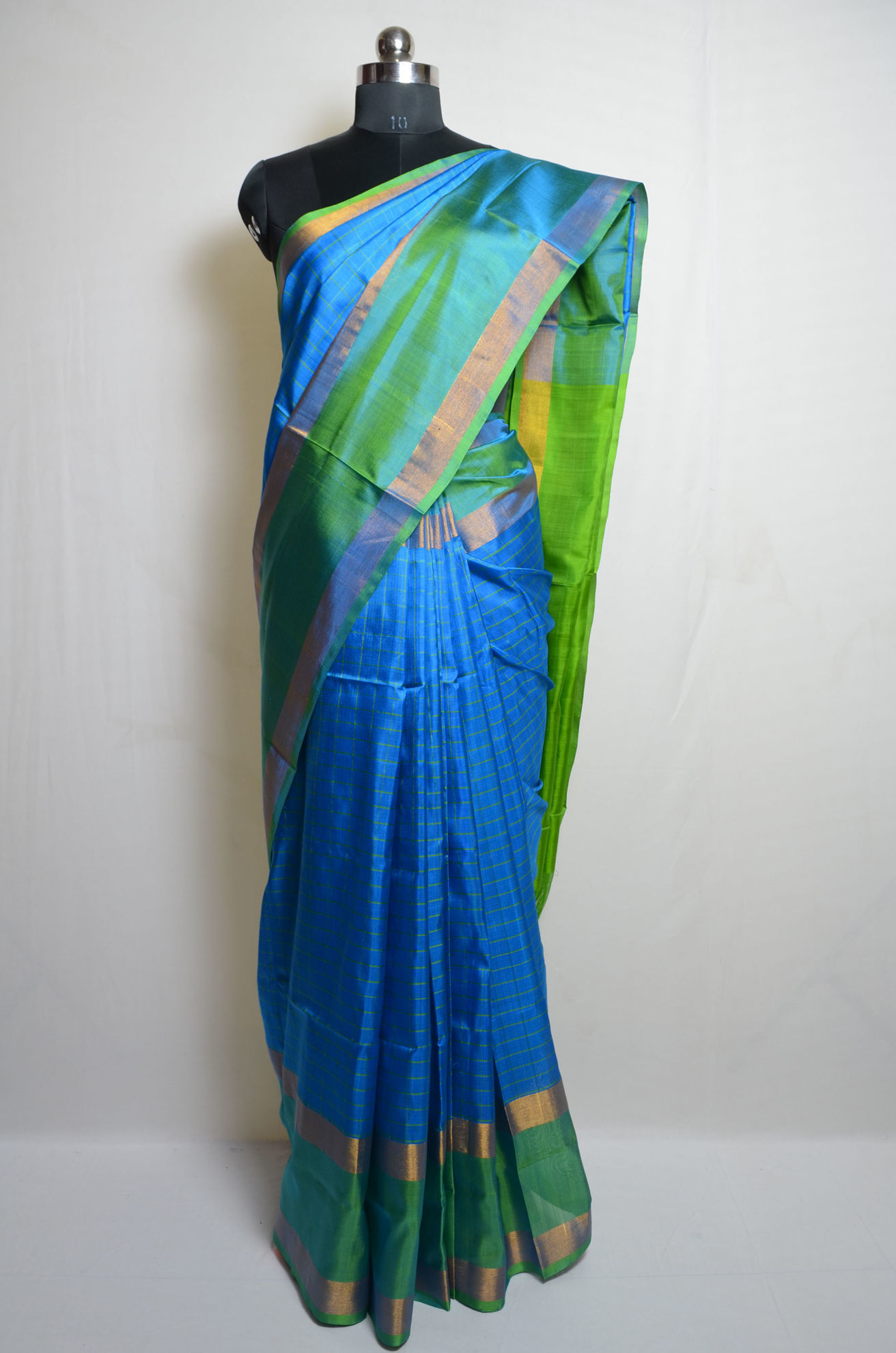 Tvis and Bliss. Anand Blue and Parrot Green Checks Uppada Silk Saree