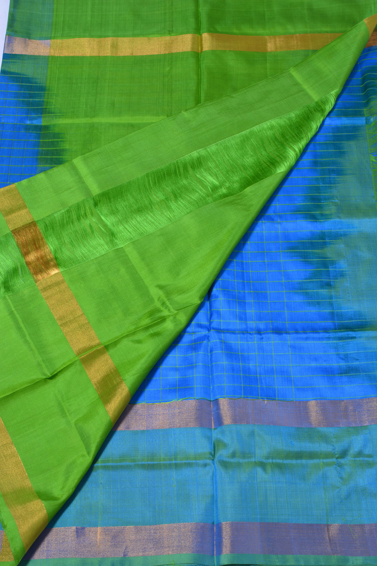 Tvis and Bliss. Anand Blue and Parrot Green Checks Uppada Silk Saree